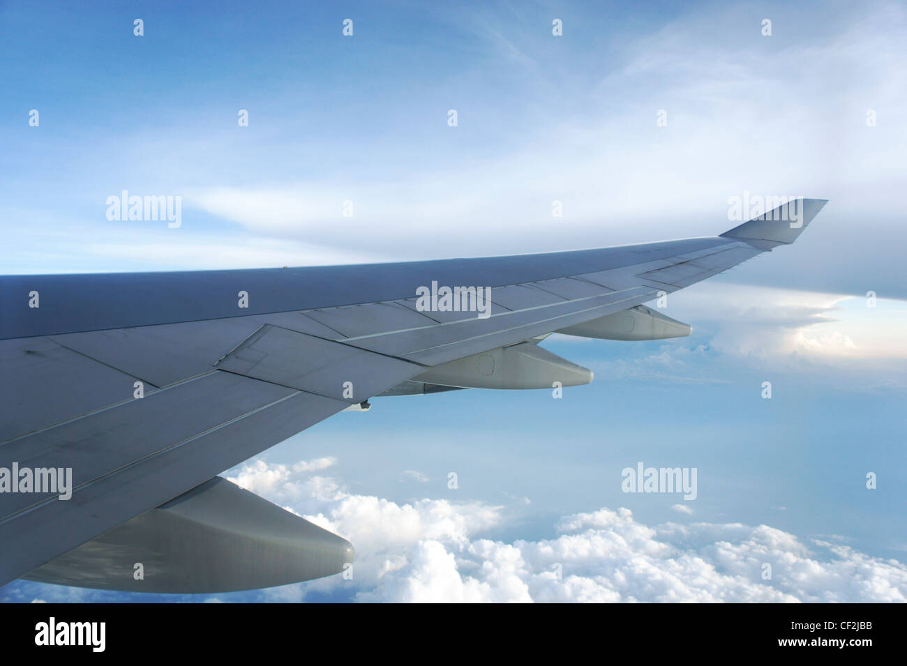 View of jet plane wing with cloud sky Stock Photo - Alamy