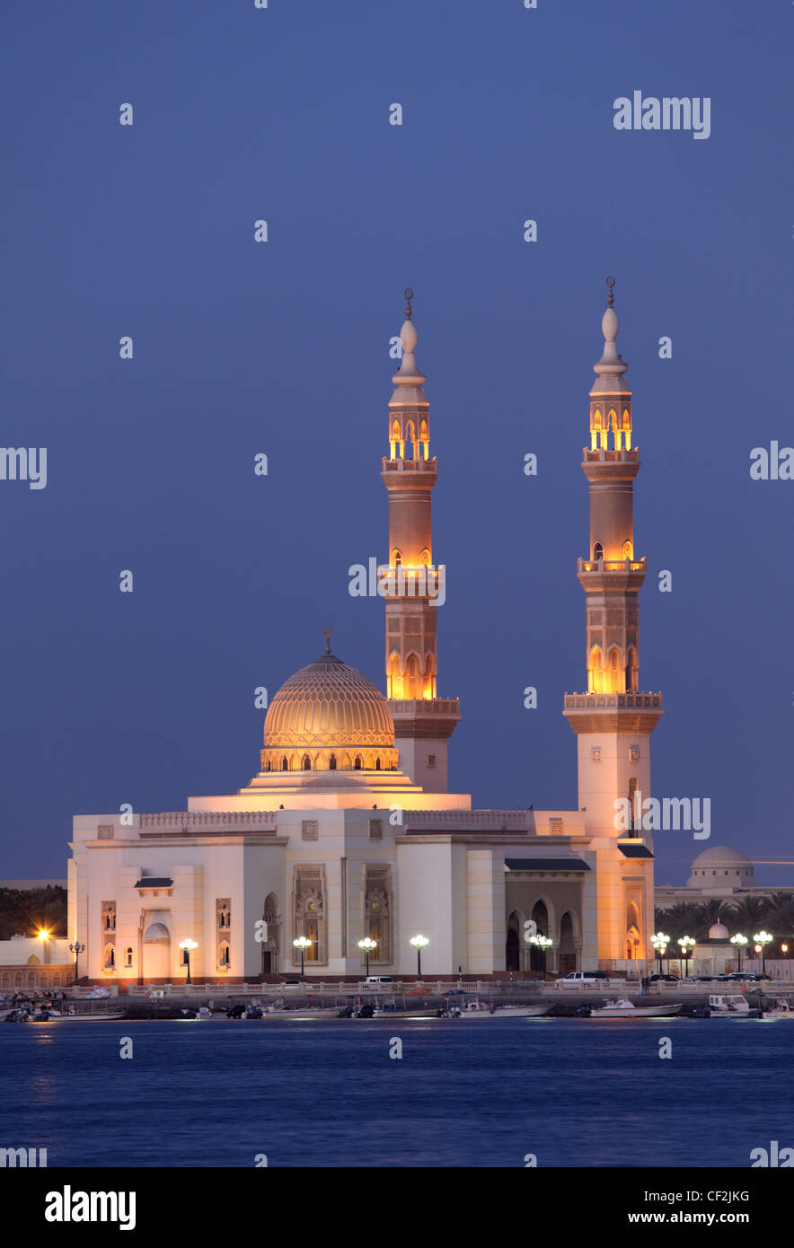 Mosque in Sharjah illuminated at dusk, United Arab Emirates Stock Photo ...