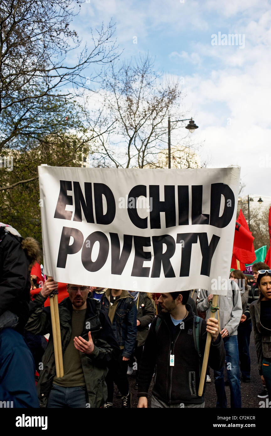 Protestors marching holding a banner stating 'End Child Poverty' at the ...