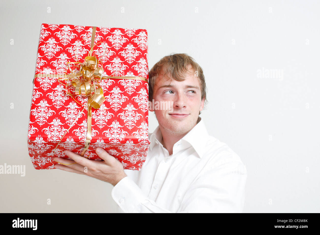 A man trying to guess a present Stock Photo - Alamy
