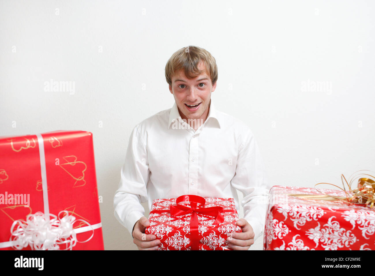 A man with a christmas present Stock Photo - Alamy