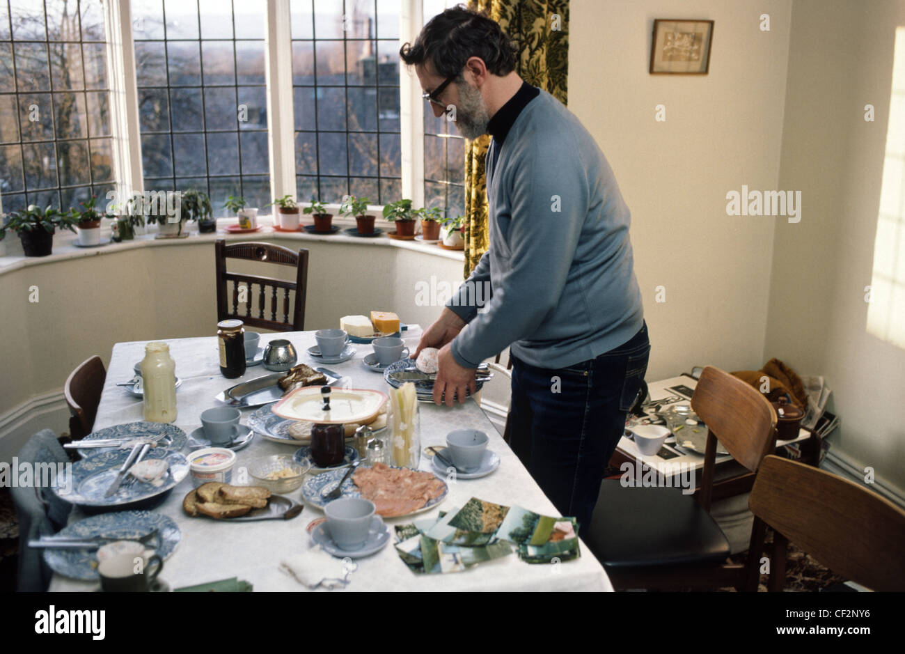 Clearing up dinner table after afternoon tea Stock Photo - Alamy