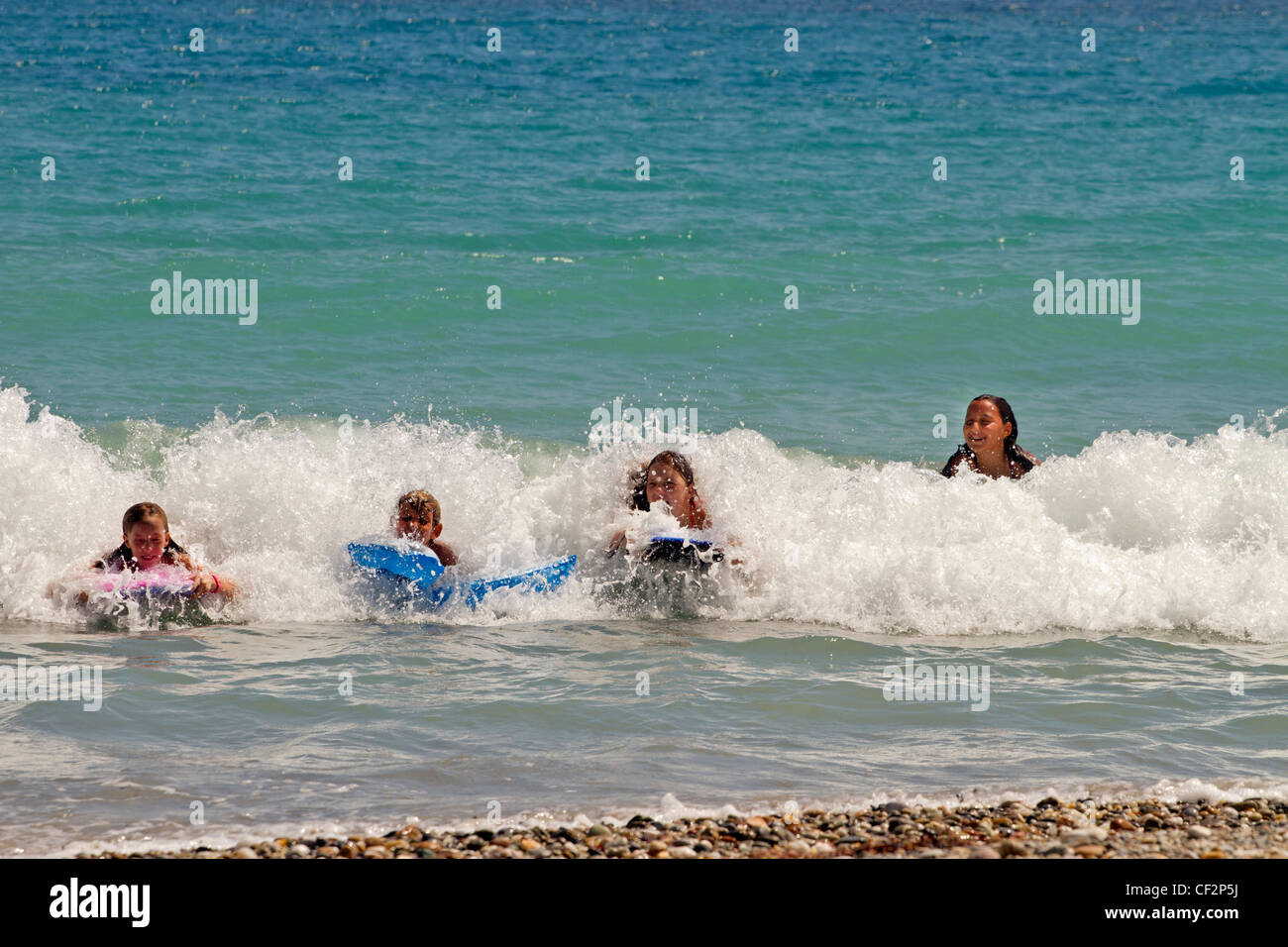 kids playing with waves Stock Photo - Alamy