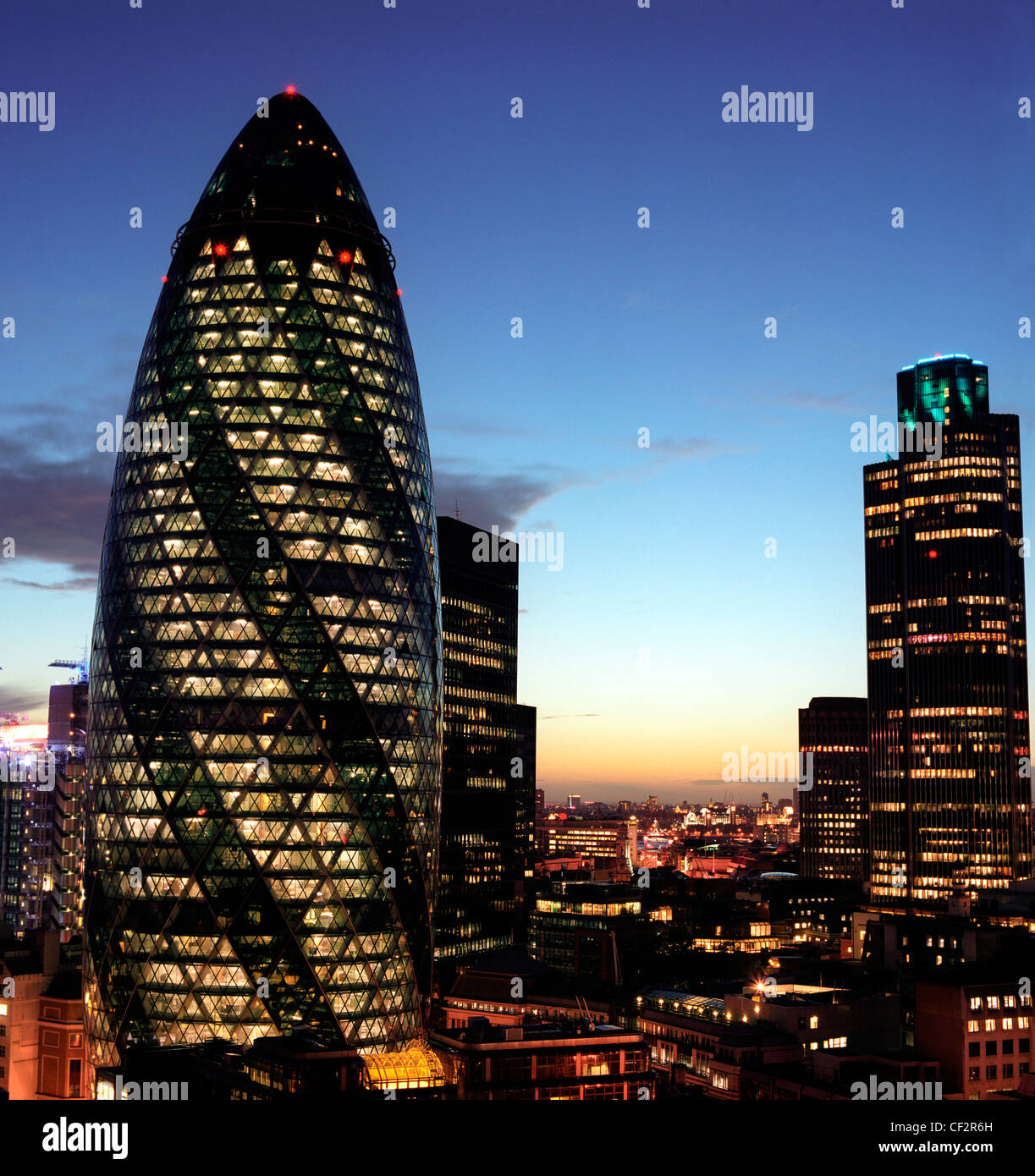 The Gherkin and Natwest Tower buildings in London at night Stock Photo ...