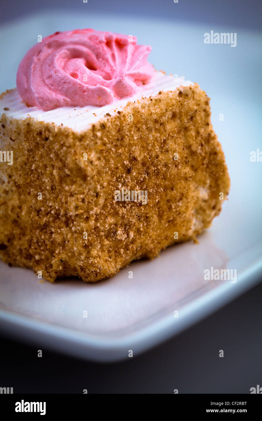 Little Square Cake with pink sugar icing Stock Photo - Alamy