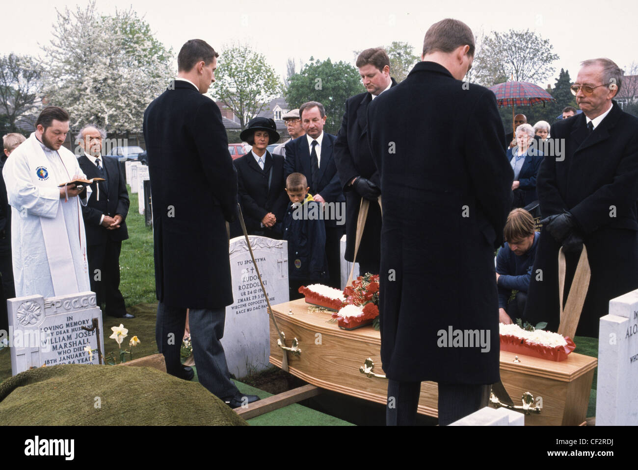 Coffin lowered hi-res stock photography and images - Alamy