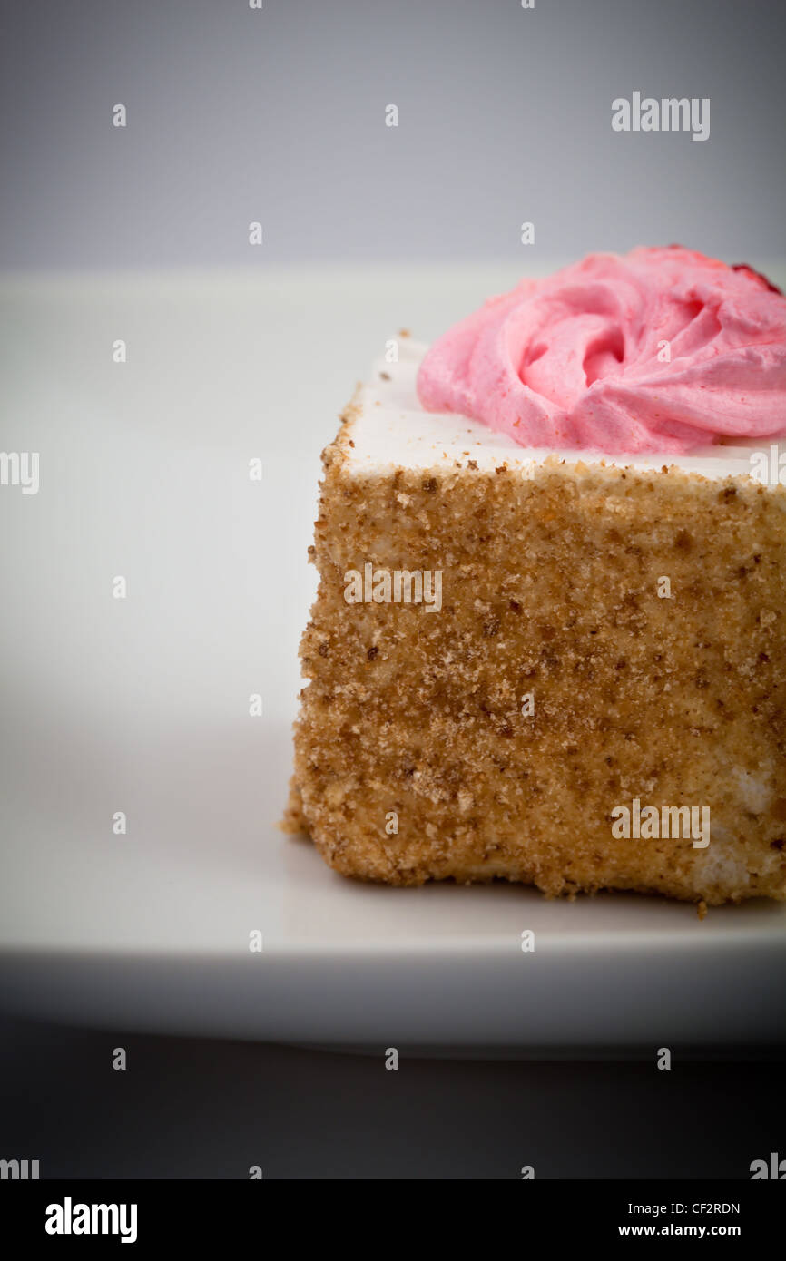 Little Square Cake with pink sugar icing Stock Photo - Alamy
