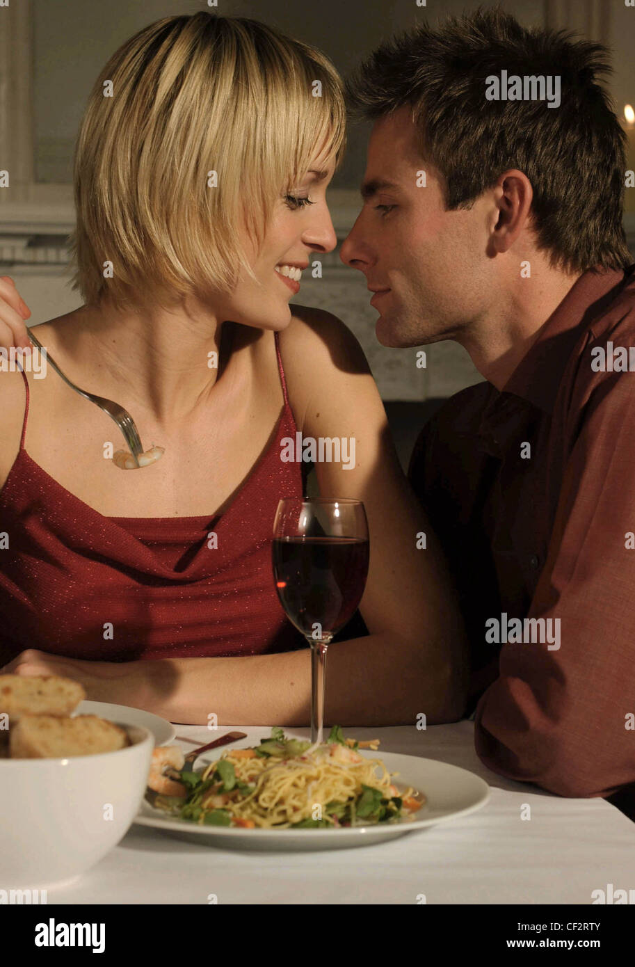 Couple eating romantic meal profile of female on left chin length ...