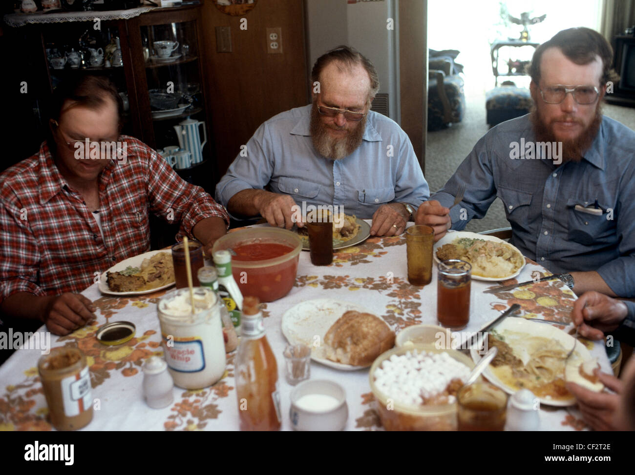 3 farmers sitting down to a classic 70's meal of meatloaf and sweet ...