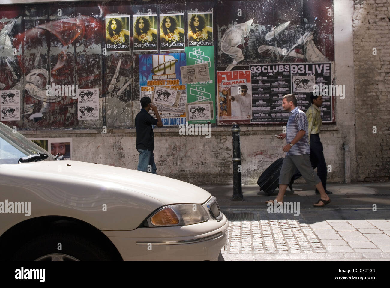 Posters on a wall in Brick Lane. Brick Lane is the heart of the city's ...