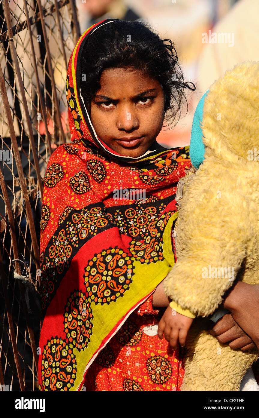 A girl with a child in subzi mandi (fruit and vegetable wholesale ...