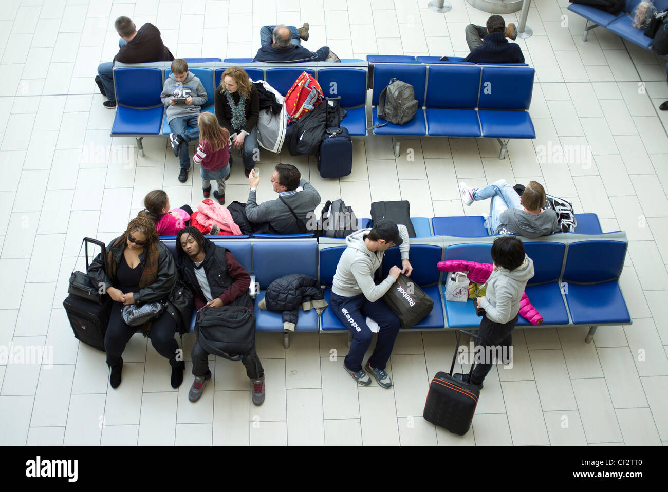 people sitting in an airport departure lounge Stock Photo - Alamy