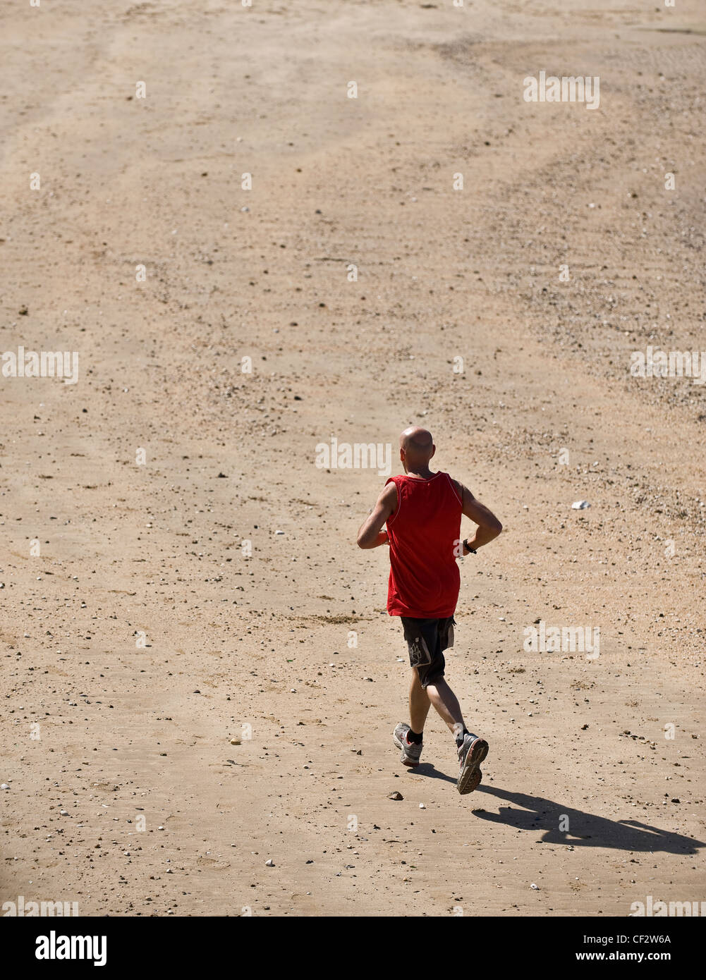 A man running along the sandy beach at Margate Stock Photo - Alamy