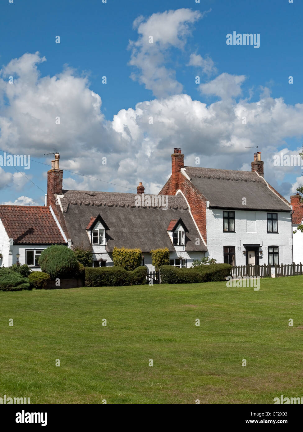 Thatched Cottages on The Green in the historical village of Martham in ...