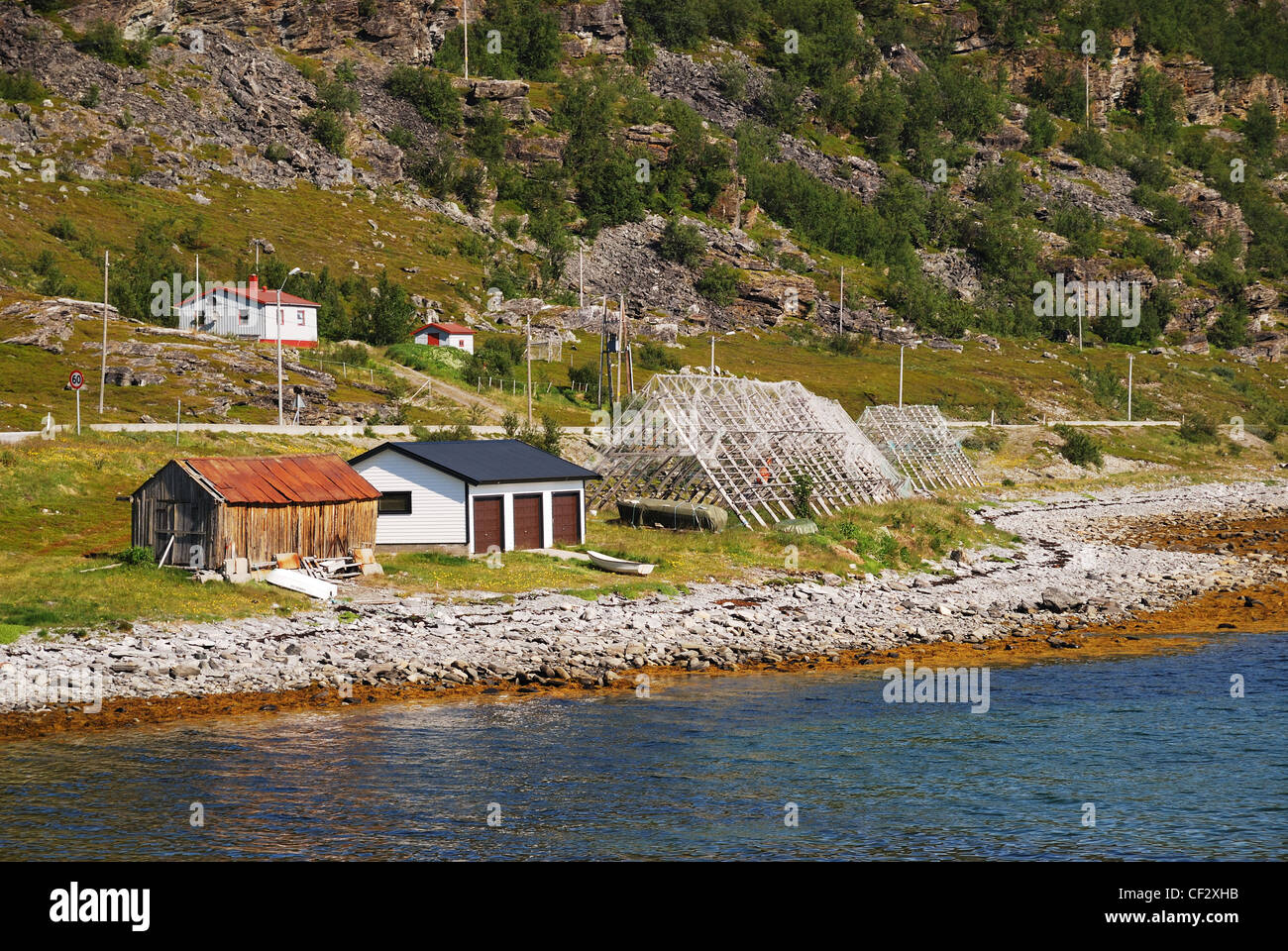 Norwegian shore with wooden rack for drying cod Stock Photo - Alamy