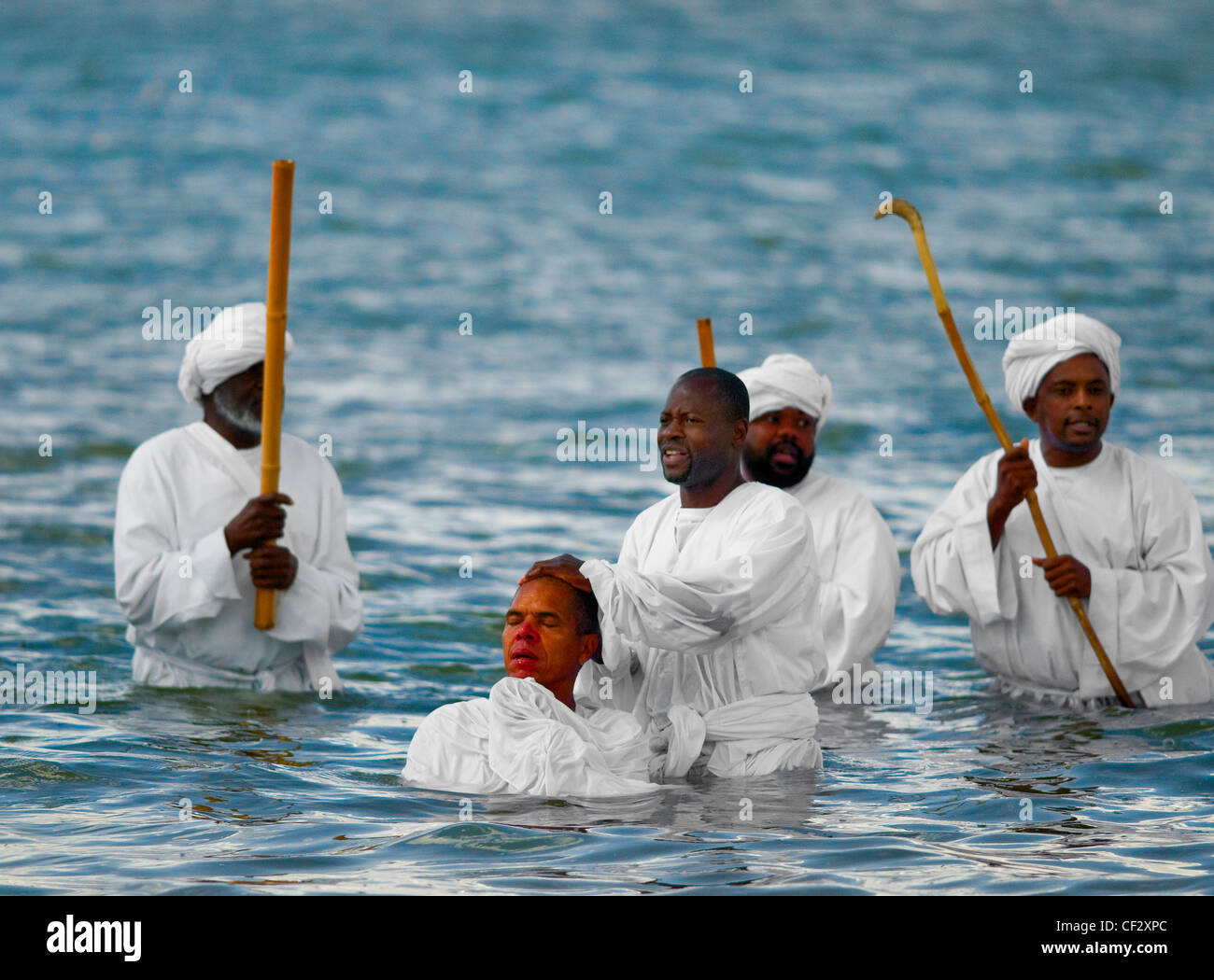 A member of an apostolic church being baptised in sea at Southend-on ...