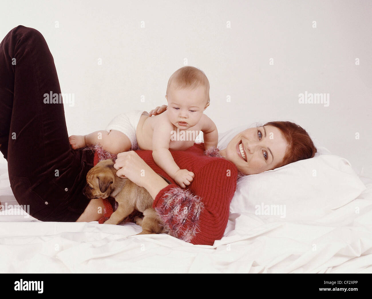 Warm and cuddly mother and baby Female red hair wearing red wool jumper ...