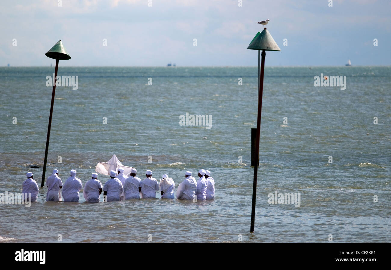 Members of an apostolic church preparing for a baptism in the sea at ...