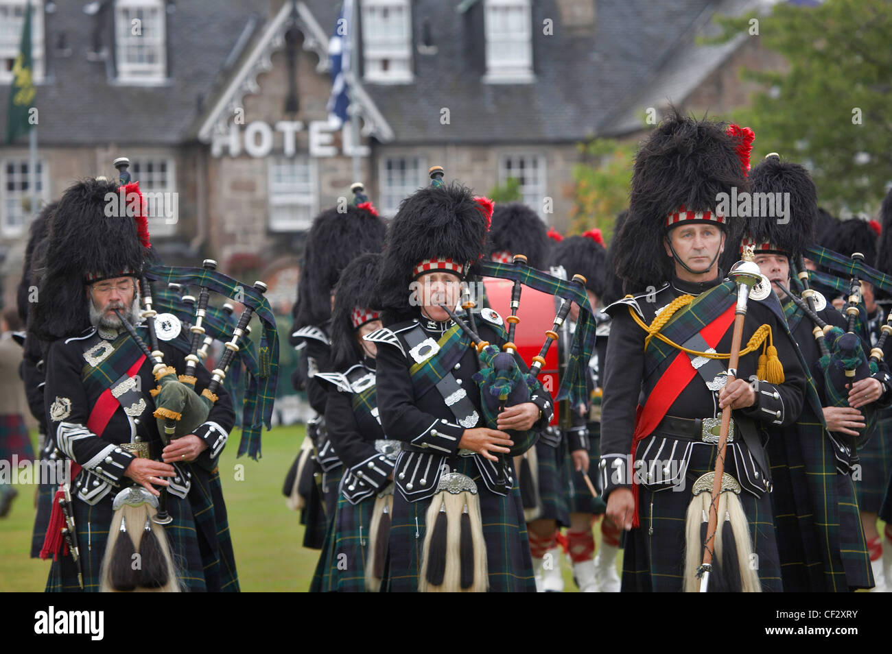Pipers marching at the Lonach Gathering and Highland Games, (billed as ...