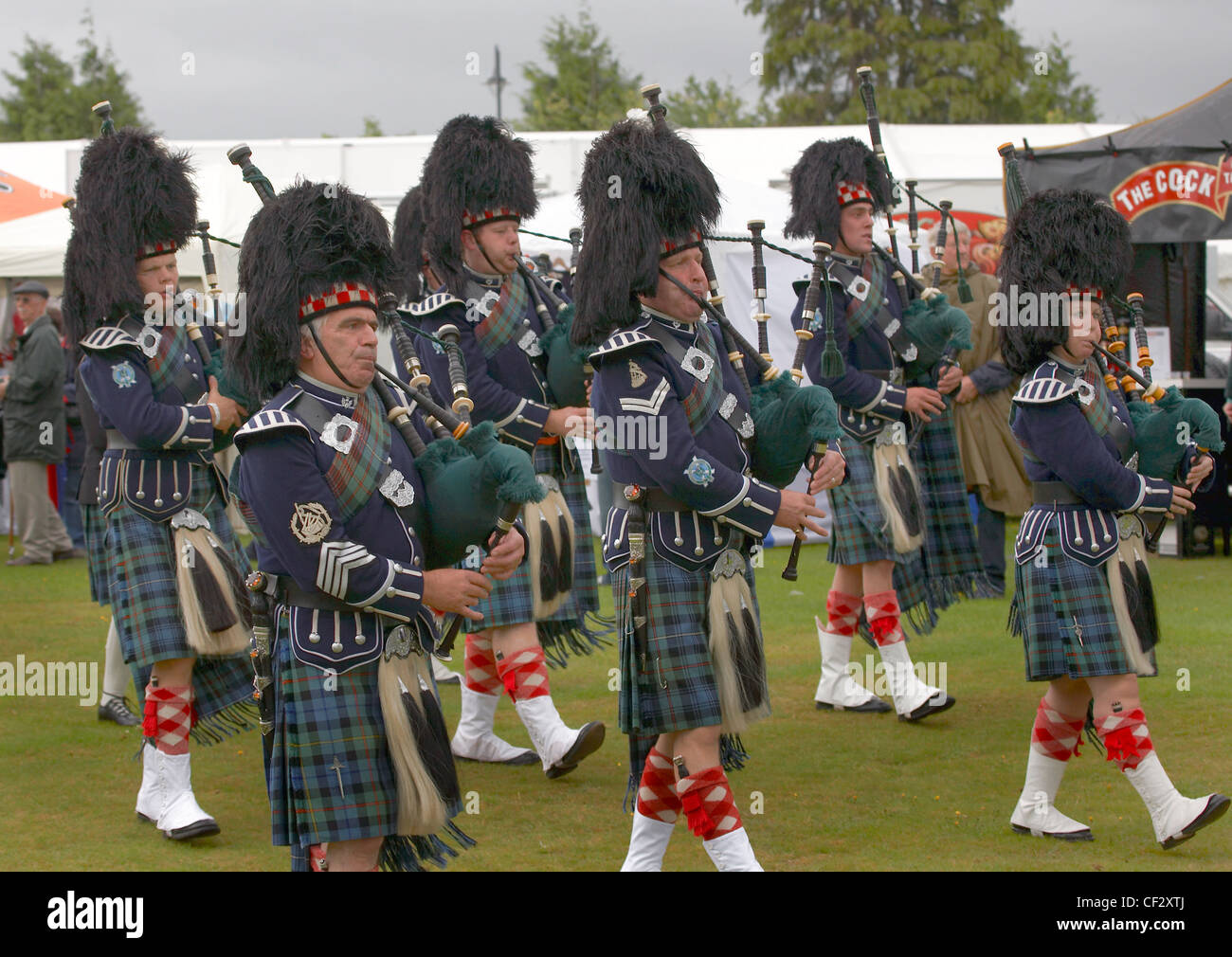 A marching pipe band performing at the Lonach Gathering and Highland ...