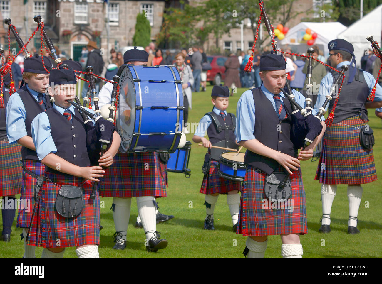 A youth pipe band marching at the Lonach Gathering and Highland Games ...
