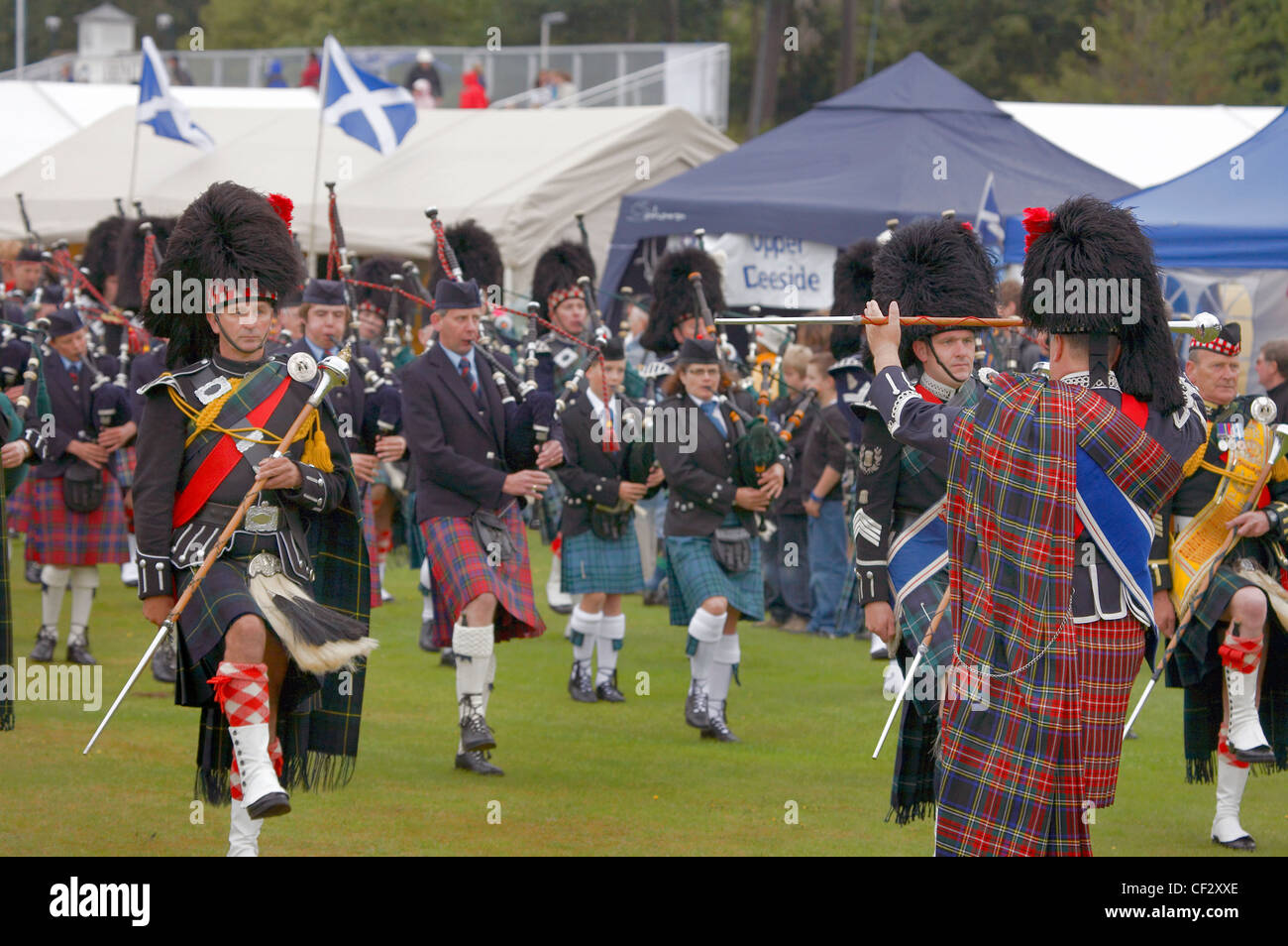 A marching pipe band performing at the Lonach Gathering and Highland ...