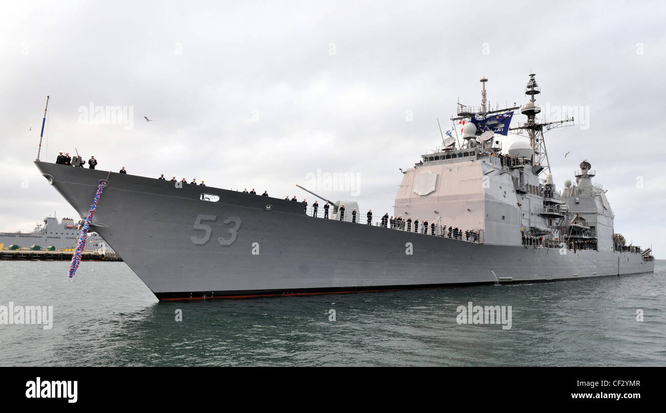 Sailors man the rails as the guided-missile cruiser USS Mobile Bay ...