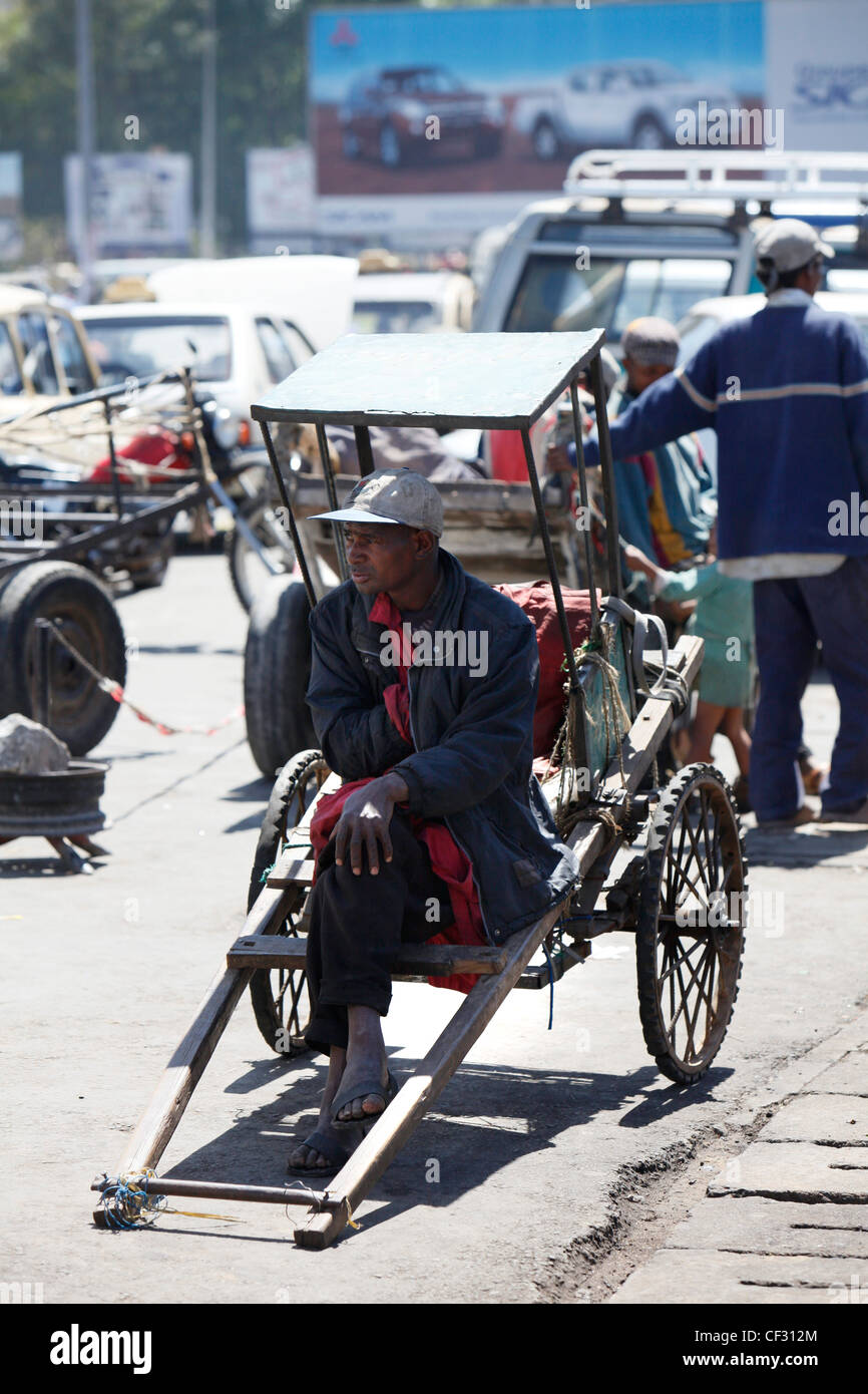 Rickshaw puller waiting for customers, City street scene, R Dok Rav ...