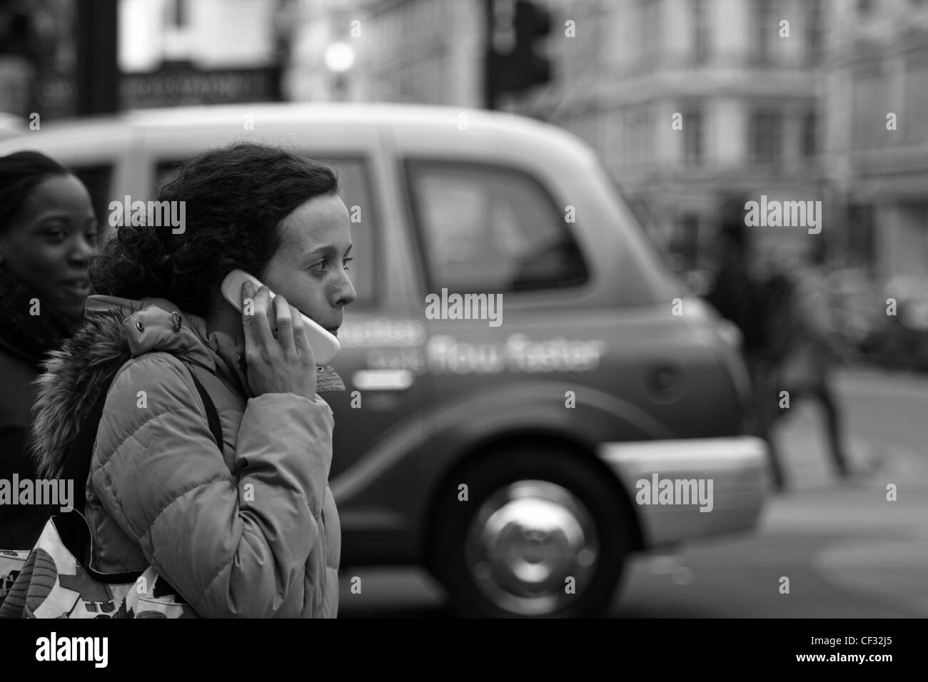 a woman using a mobile phone in a street Stock Photo - Alamy