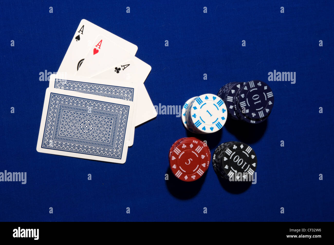Poker hand layed out on blue background with two hidden cards and four ...