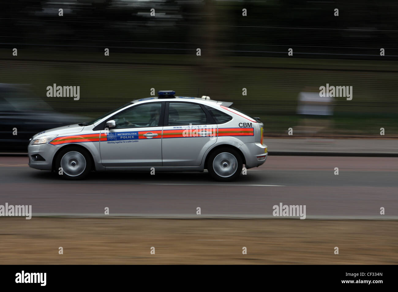 A metropolitan police car traveling along a road in London Stock Photo ...