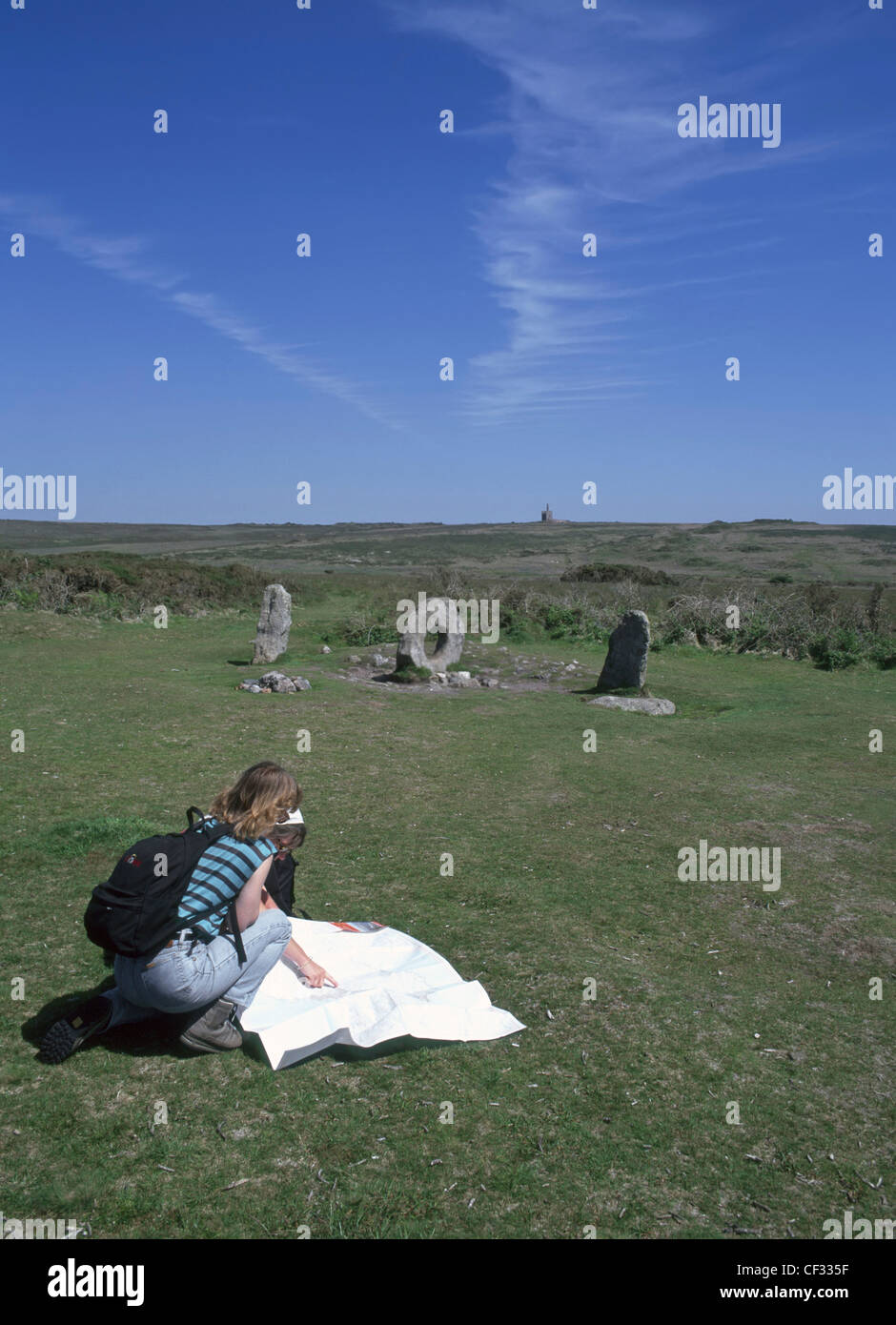 Men An Tol Cornwall ancient granite standing stones two walkers ...