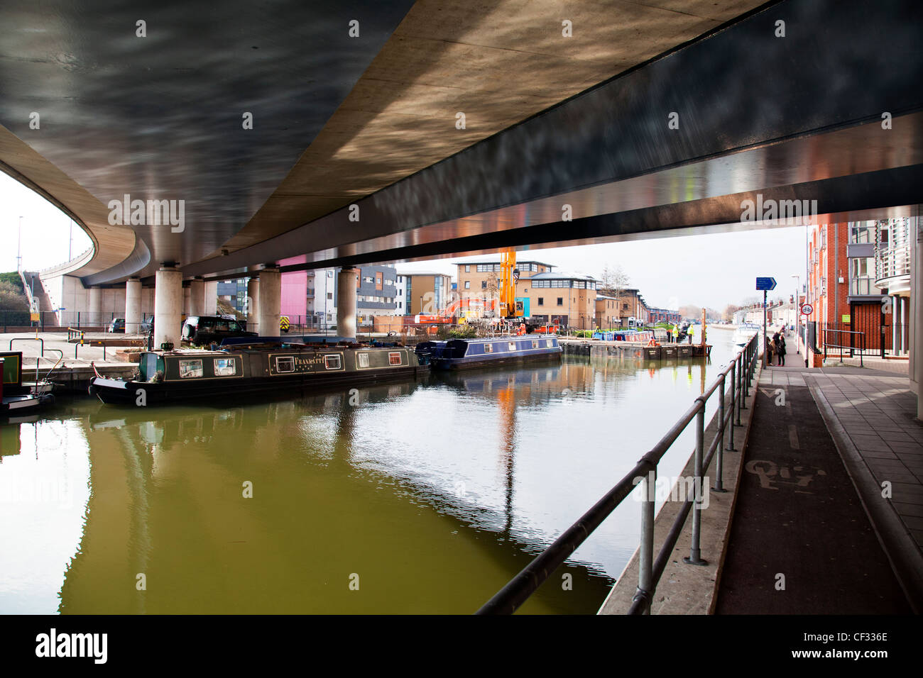 High rise tower crane lifting large floating blocks on river Witham in ...