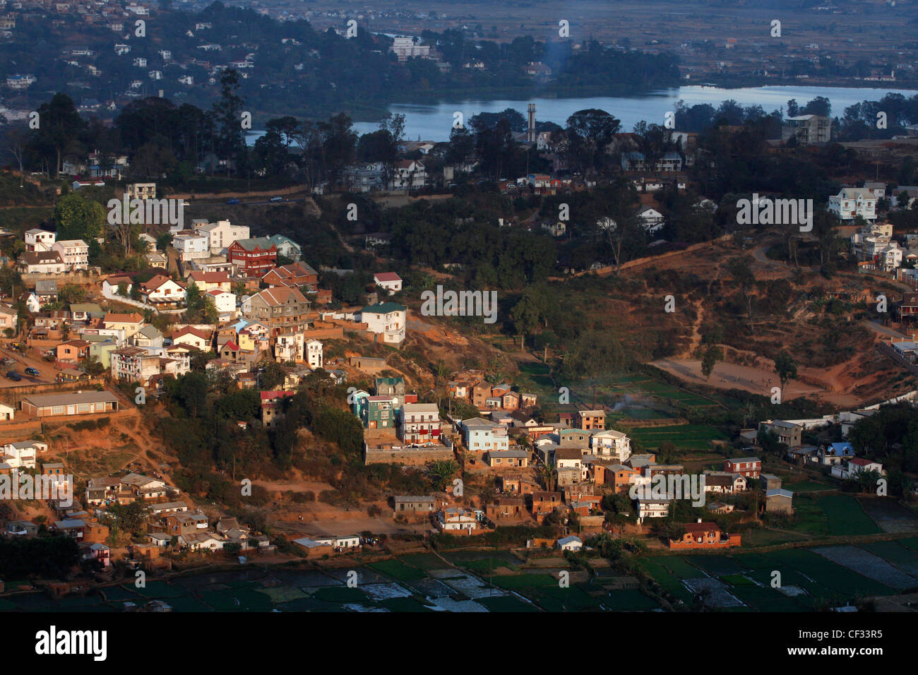 City view of housing, hills, lake and paddy fields. Antananarivo ...