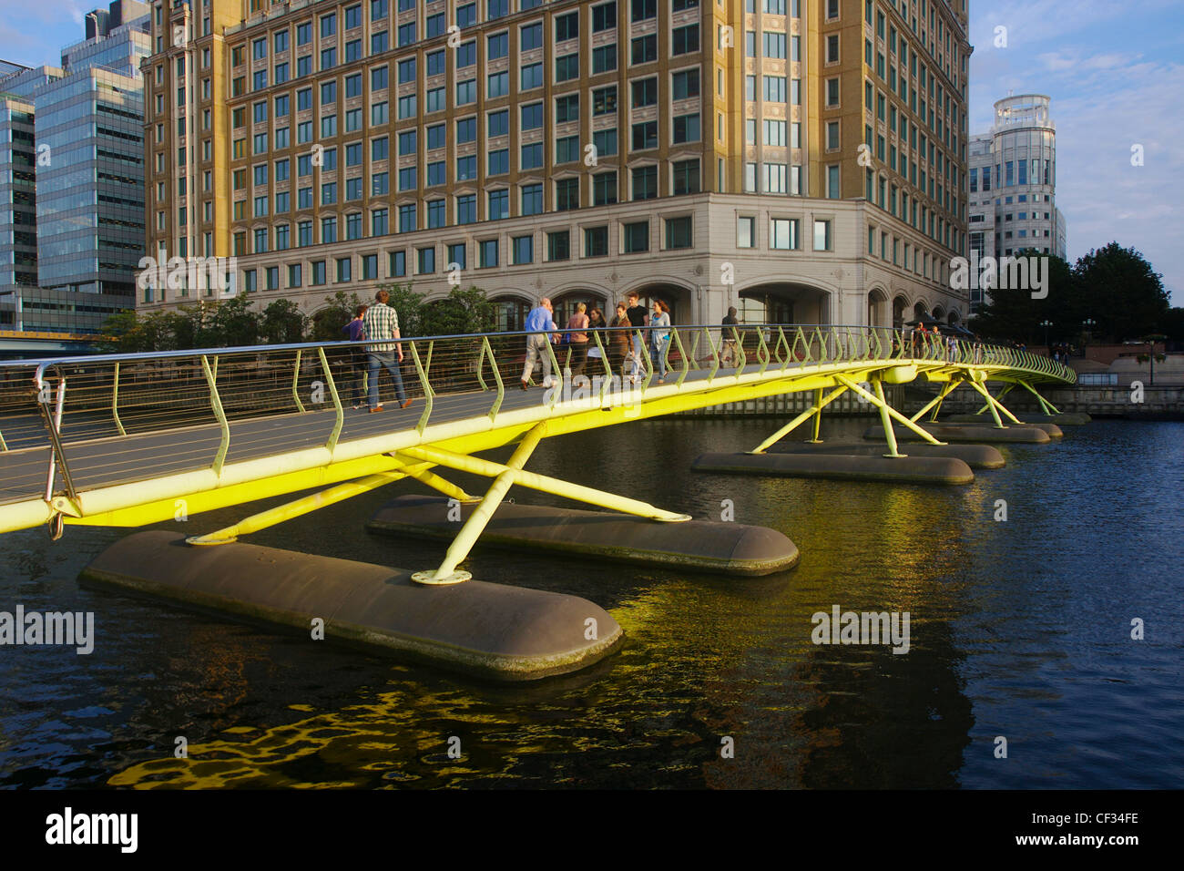 People crossing a footbridge at West India Quay on the Isle of Dogs in ...