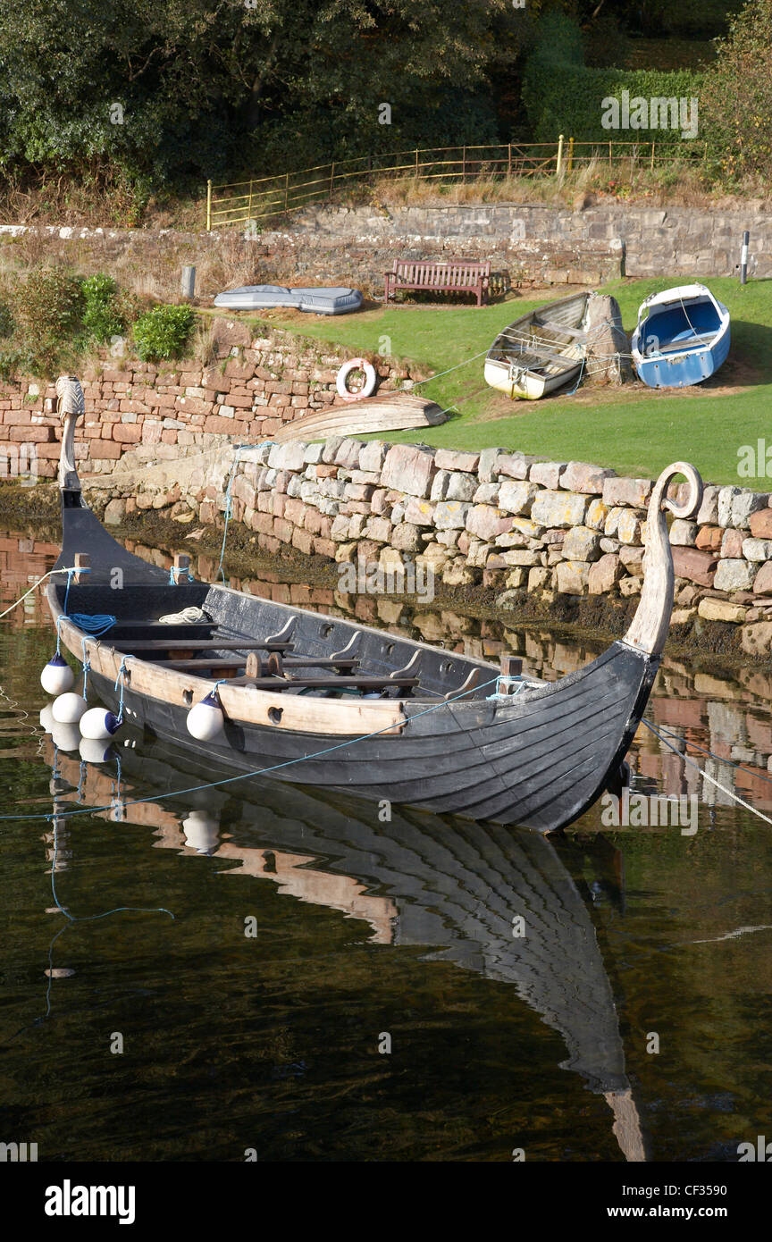A replica Viking boat in Corrie Harbour on the Isle of Arran Stock ...