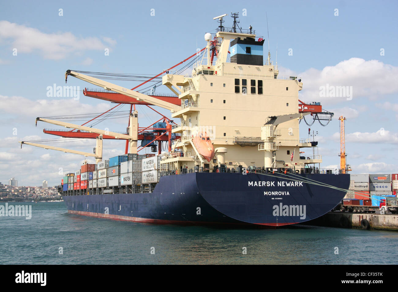 Container ship under quayside cranes in the seaport Stock Photo - Alamy