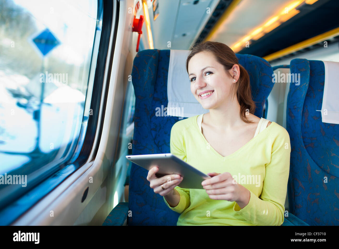 Young woman using her tablet computer while traveling by train Stock ...