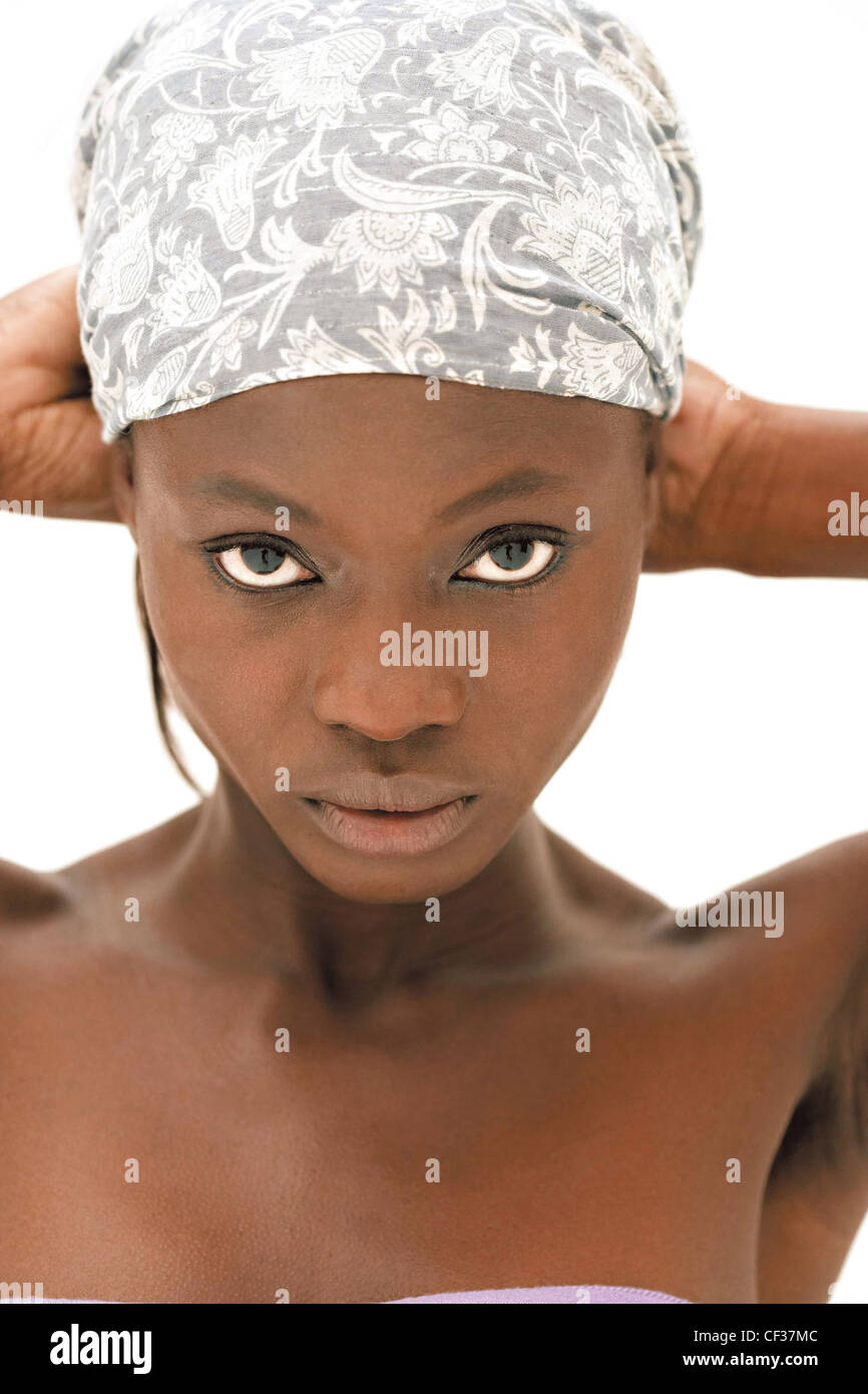 Female tying a headscarf around her head Stock Photo - Alamy