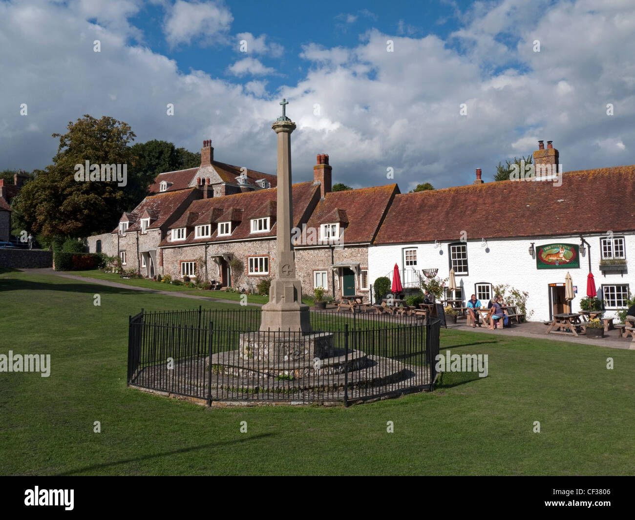 People sitting outside The Tiger Inn by the village green in East Dean ...