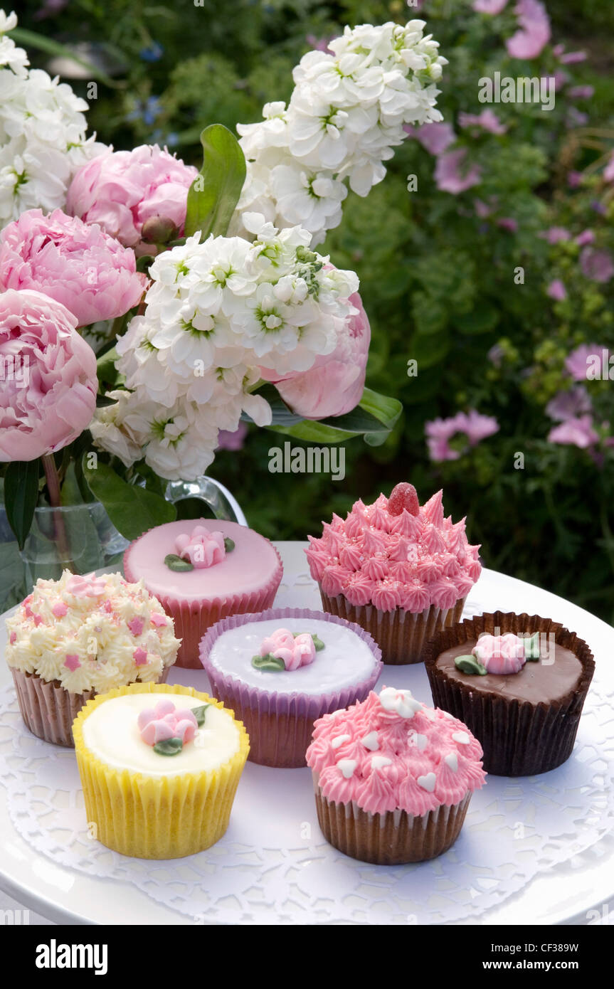 An English cream tea Cupcakes decorated with icing on a cakestand with ...