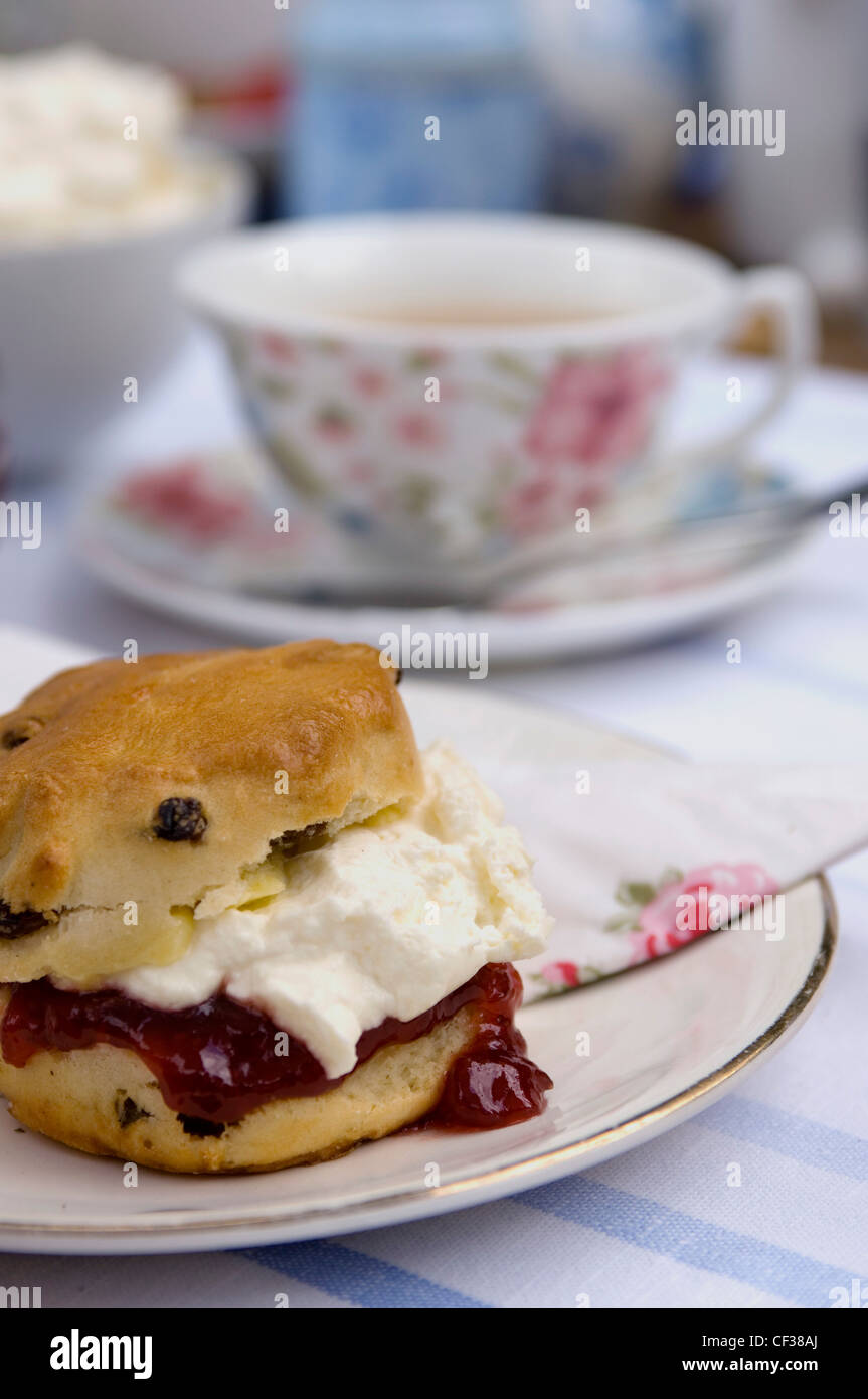 An English cream tea Scone with jam and cream and cup of tea Stock ...