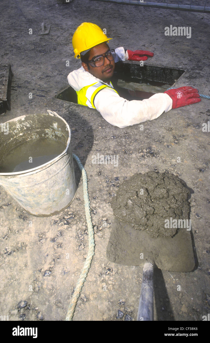 Man emerging manhole hi-res stock photography and images - Alamy