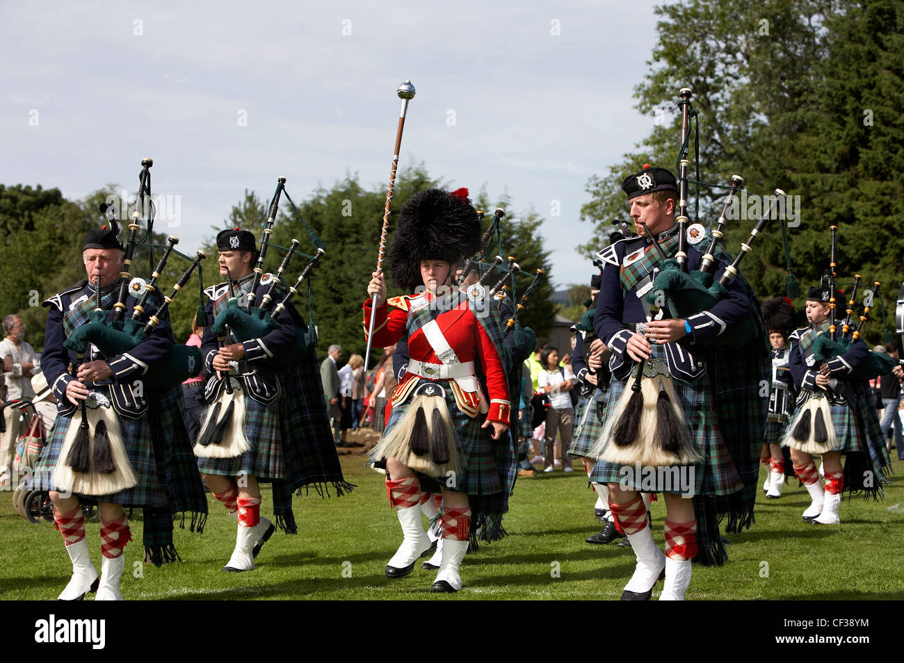 Pipers in a marching band performing at the Lonach Highland Games Stock ...
