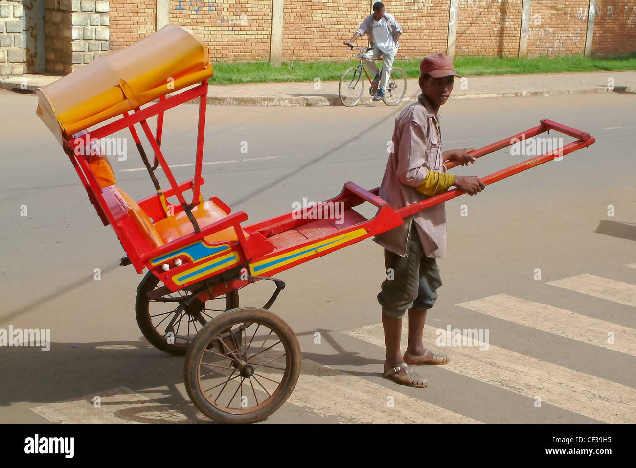 Rickshaw puller in Antsirabe, Madagascar highlands Stock Photo - Alamy