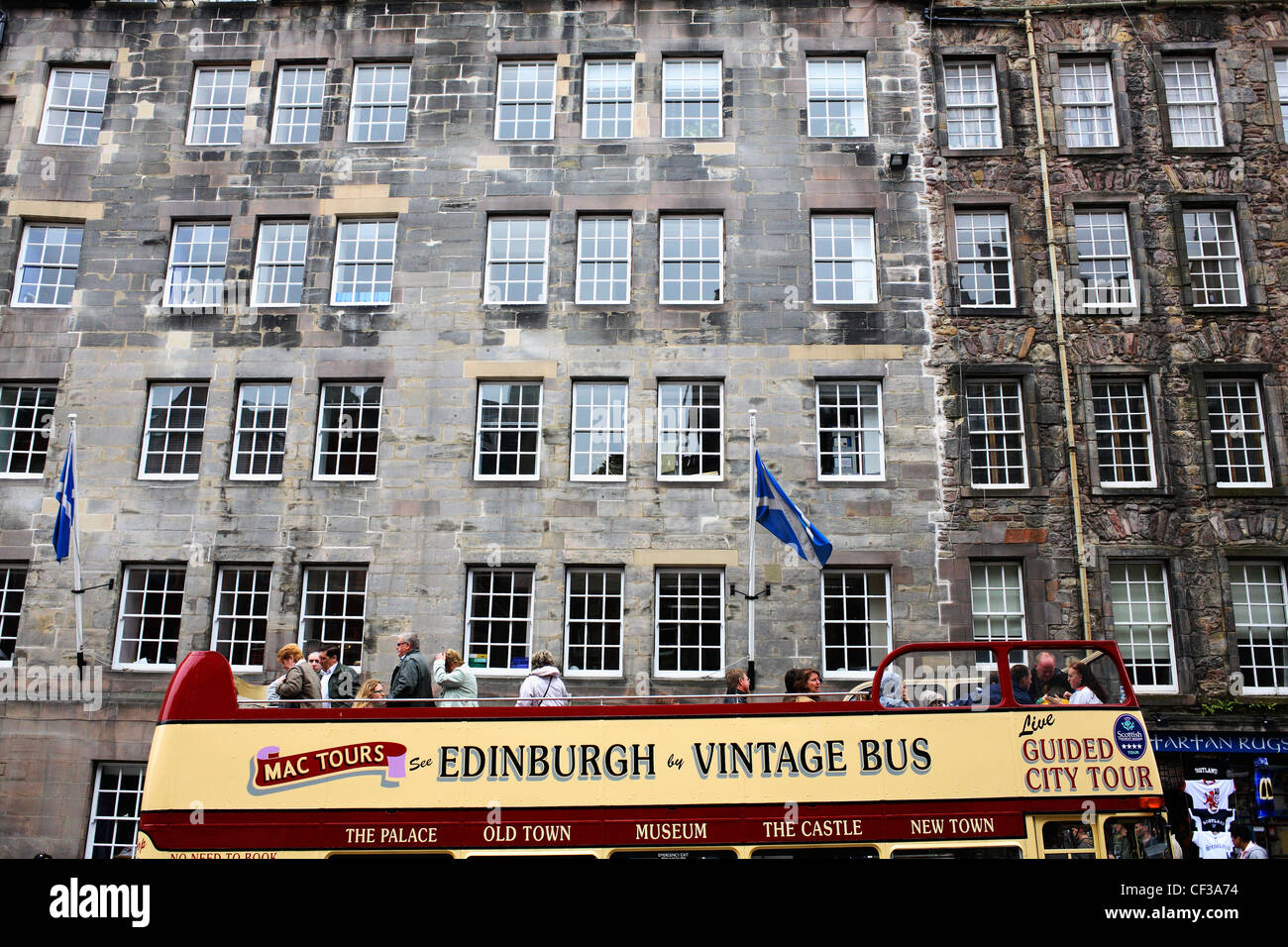 Tourists aboard an open top bus on The Royal Mile in the Old Town of ...