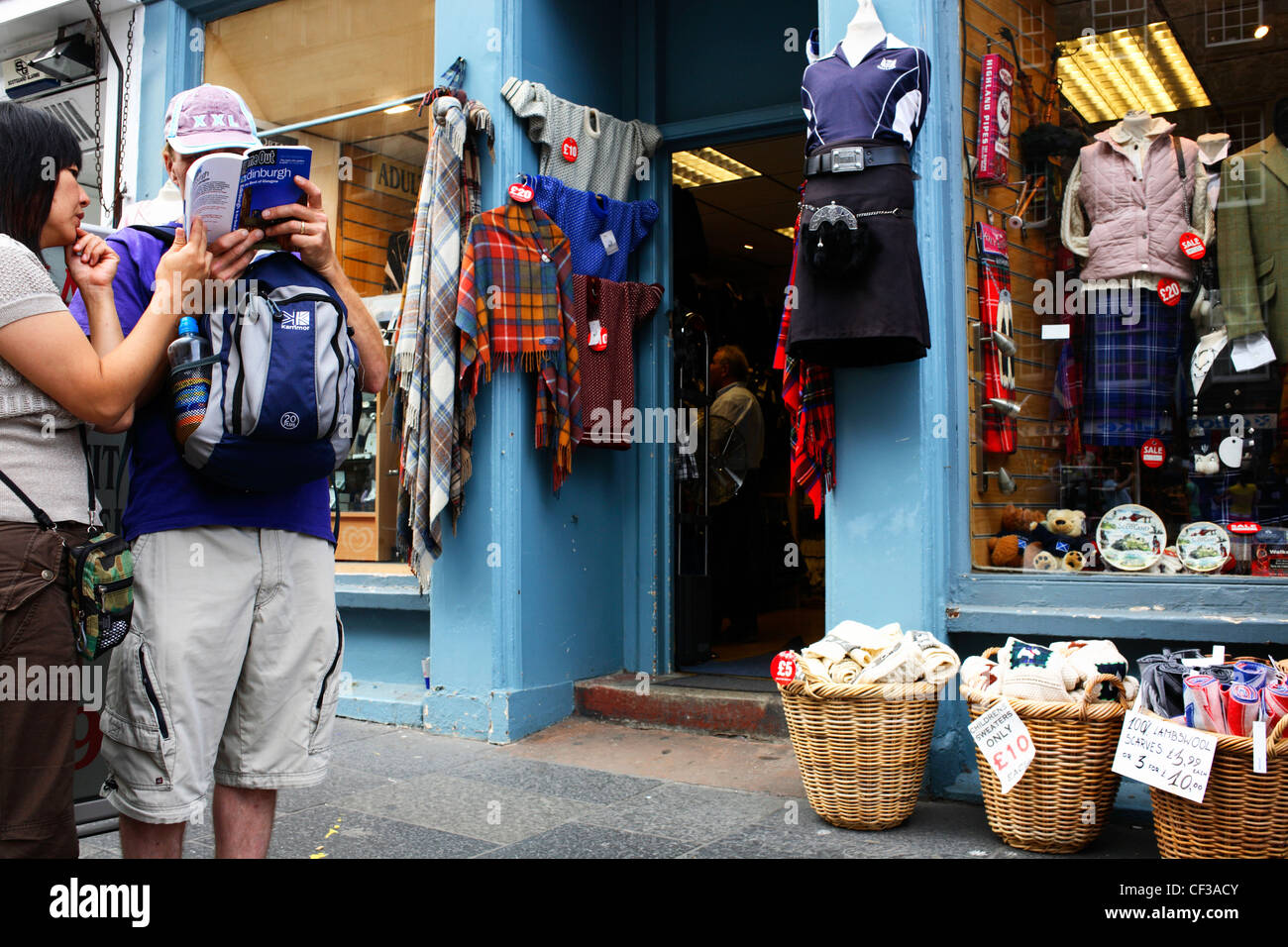 Tourists reading their Edinburgh guide book on The Royal Mile in the ...