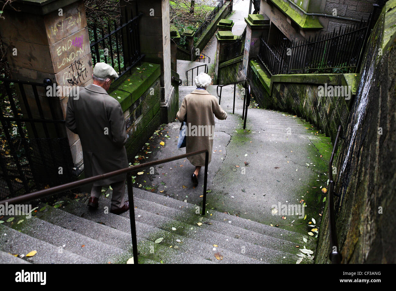 Old woman climbing down stairs hi-res stock photography and images - Alamy