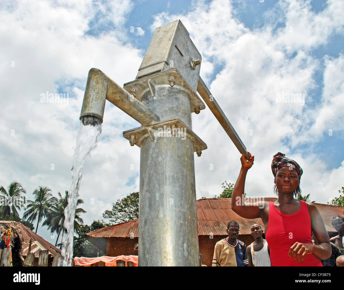 Woman pumping water from a UNDP-sponsored well near Kenema, Sierra ...
