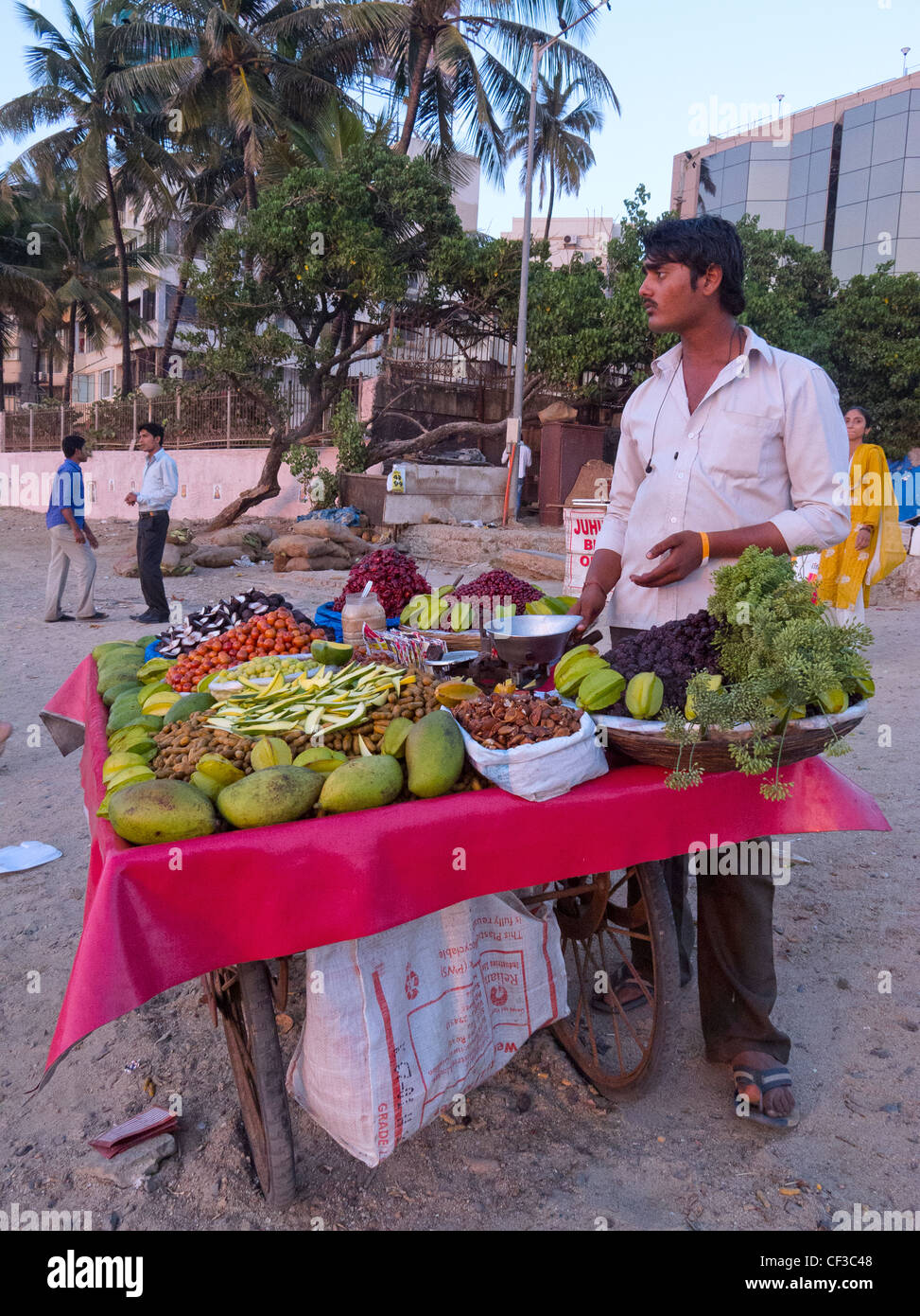 a fruit stall with a salesman at Juhu beach Mumbai, Maharashtra, India ...